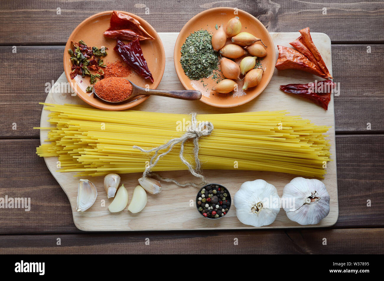 dried pasta tied with string on a wooden background with spices Stock ...