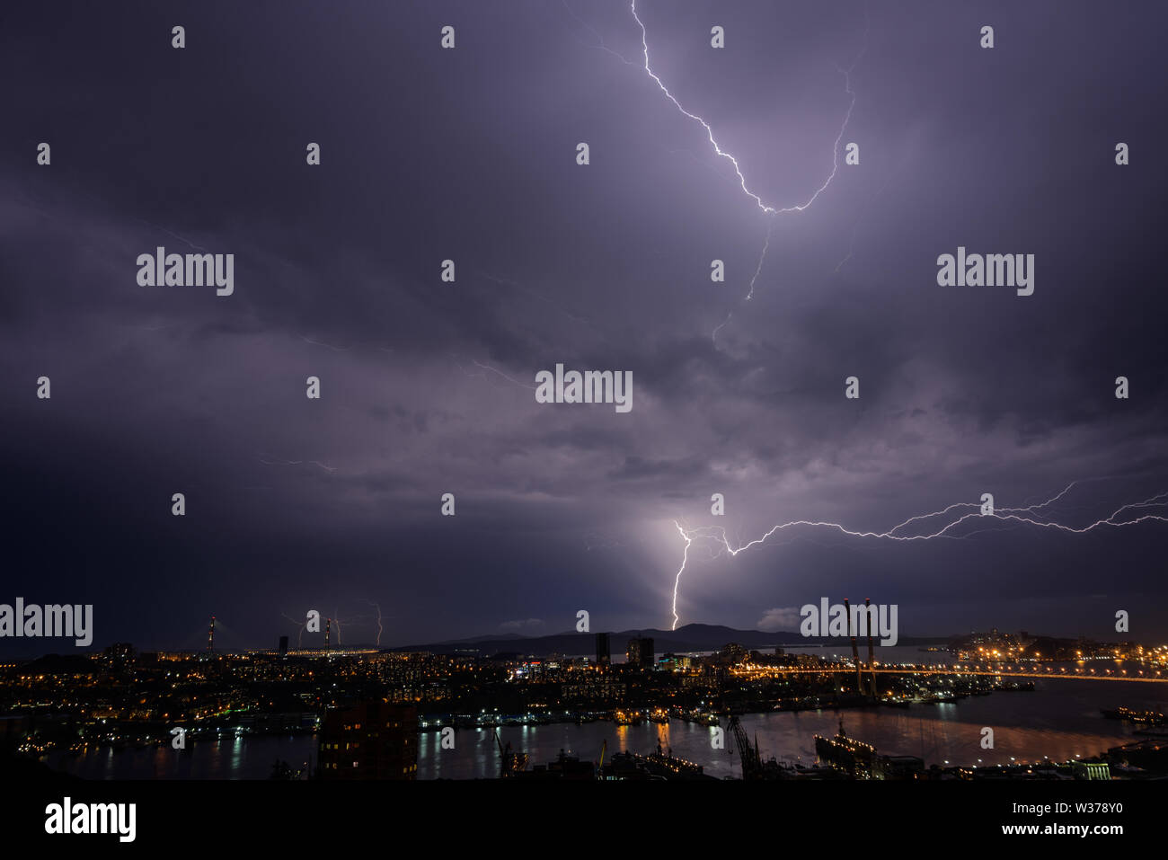Lightning storm over city Stock Photo - Alamy
