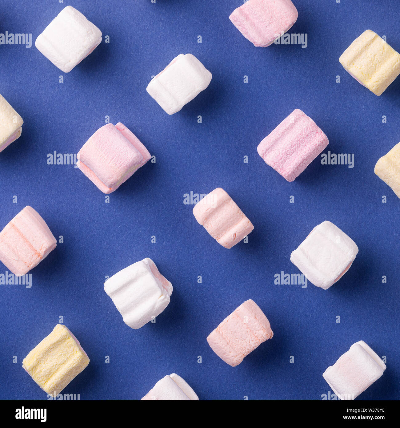 Sweet marshmallows on blue background. Minimalism concept Stock Photo ...