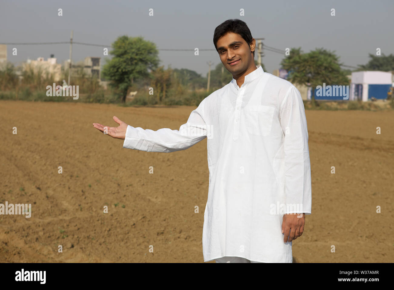 Portrait of a farmer showing his field Stock Photo - Alamy