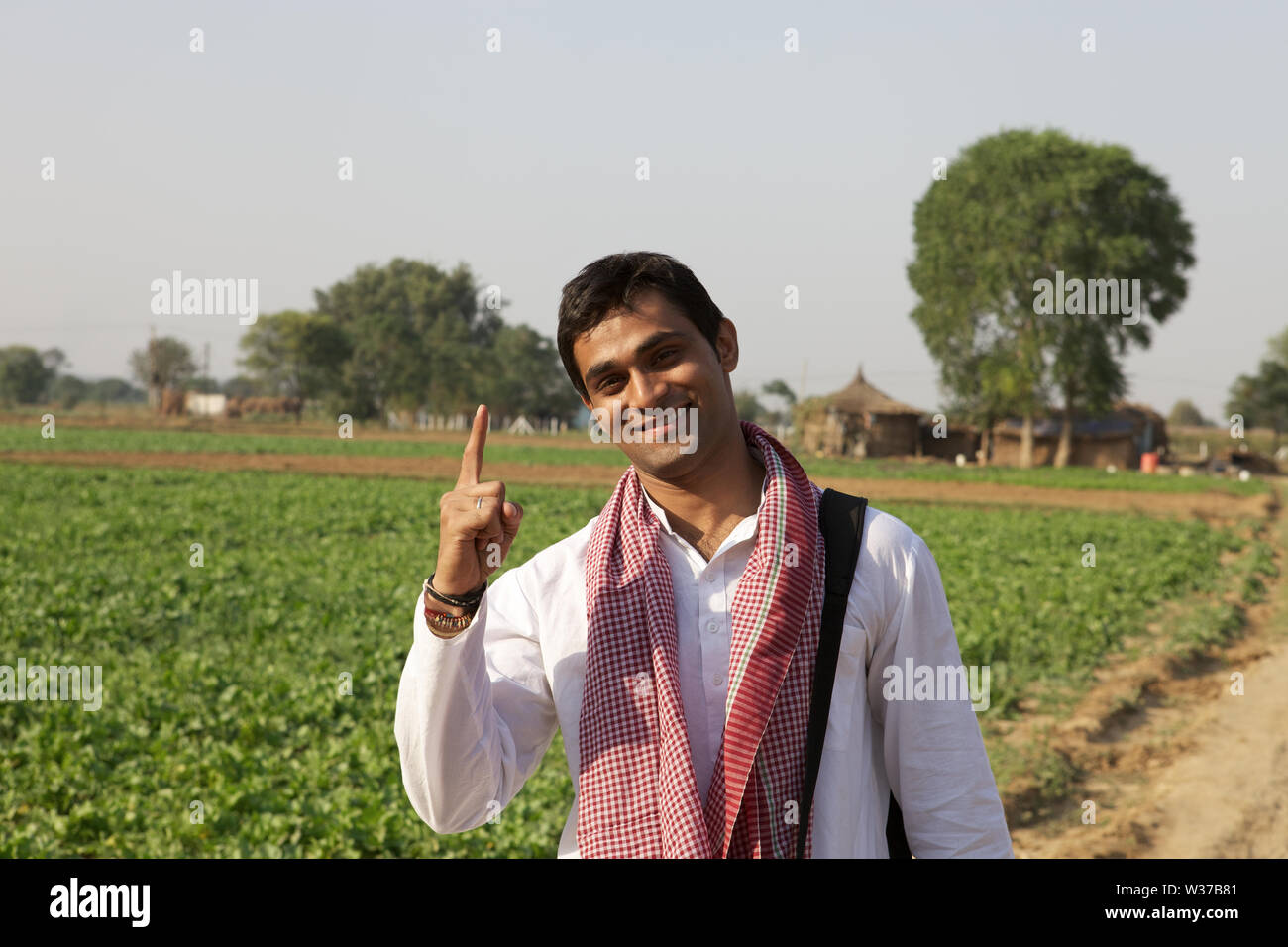 Portrait of a farmer pointing upward and smiling Stock Photo - Alamy