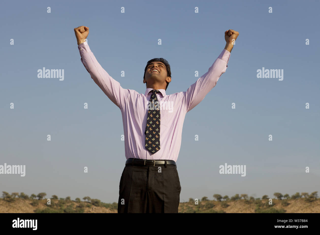 Businessman standing with his arm outstretched Stock Photo - Alamy