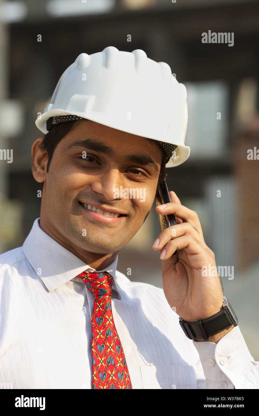 Architect talking on a mobile phone Stock Photo - Alamy