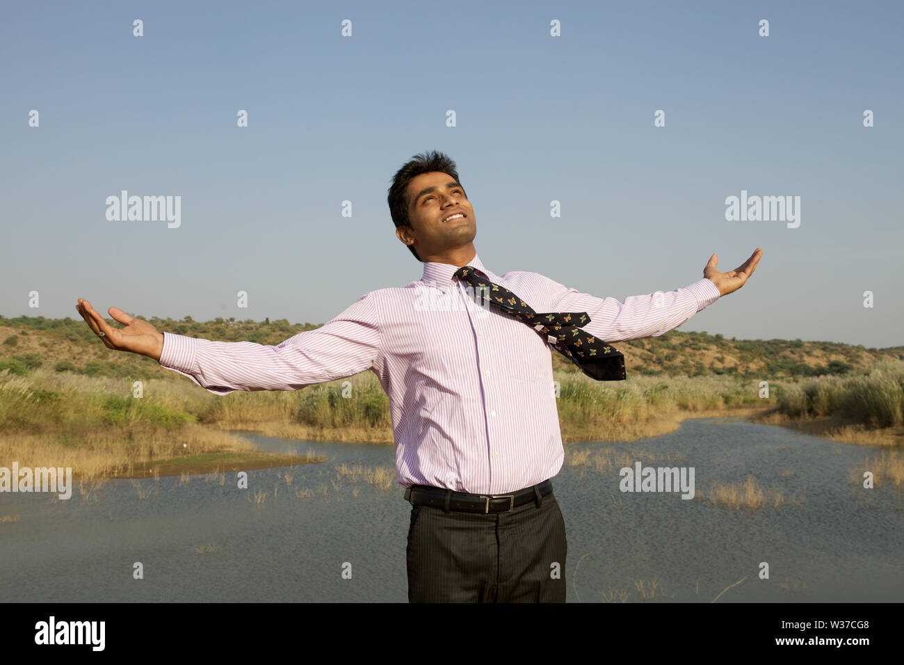 Businessman standing with his arm outstretched Stock Photo - Alamy