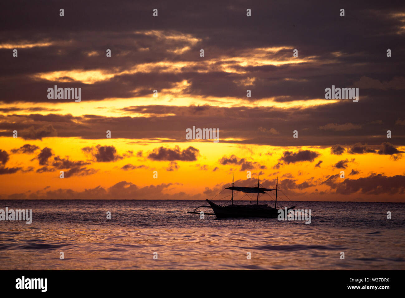boat on sea with sun reflection in water surface during sunset Stock ...
