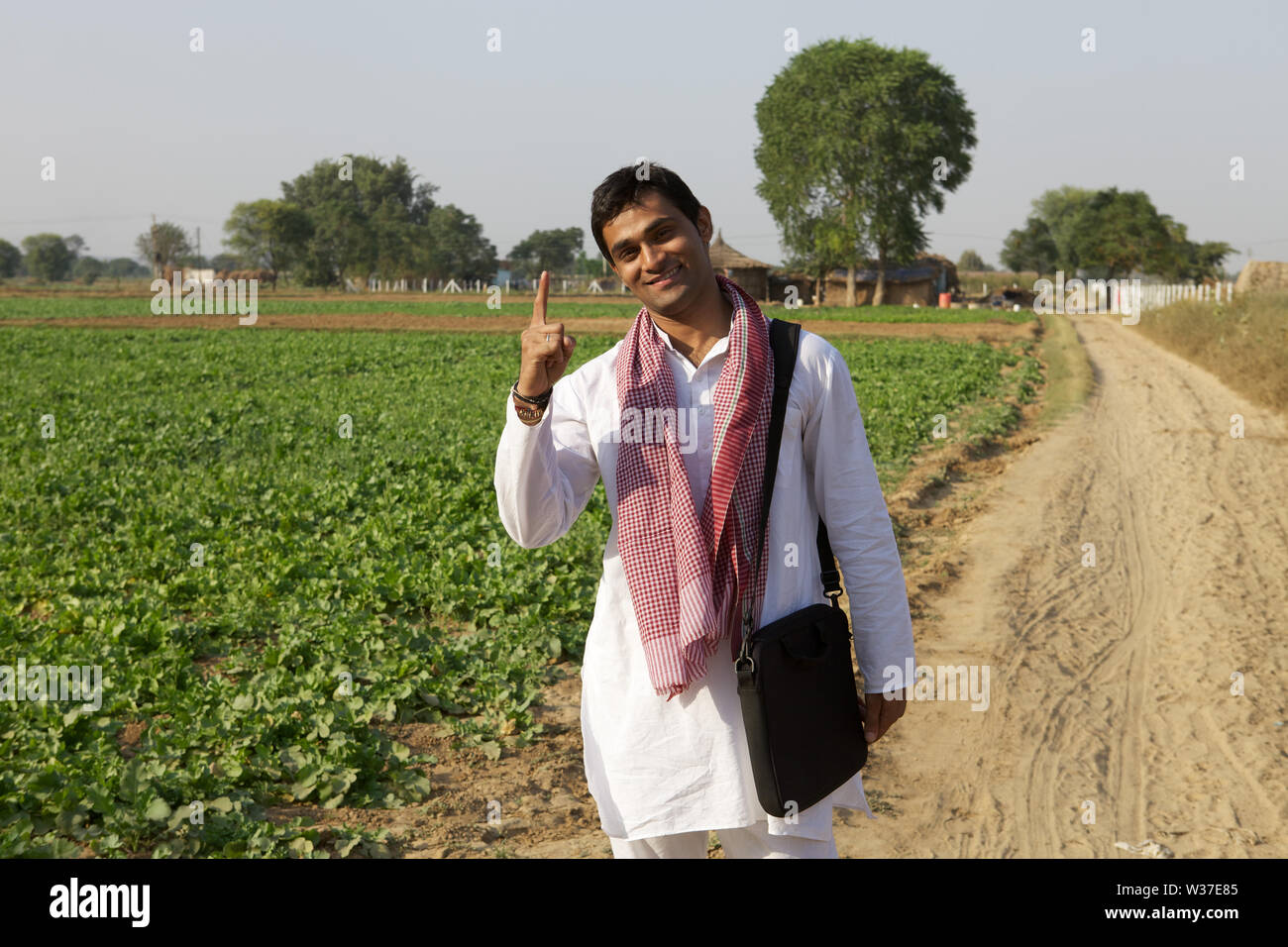 Portrait of a farmer pointing upward and smiling Stock Photo - Alamy