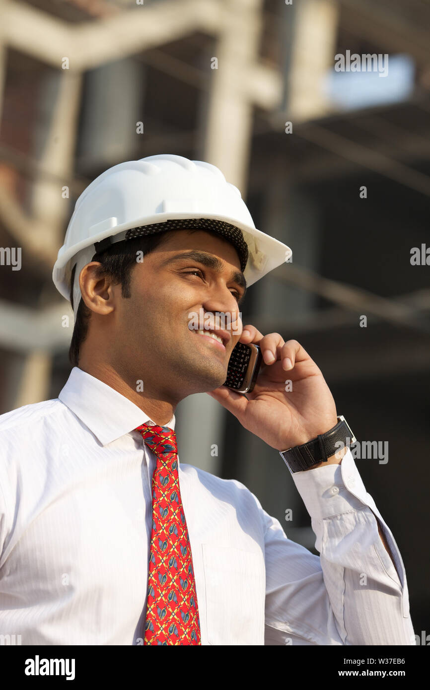 Architect talking on a mobile phone Stock Photo - Alamy