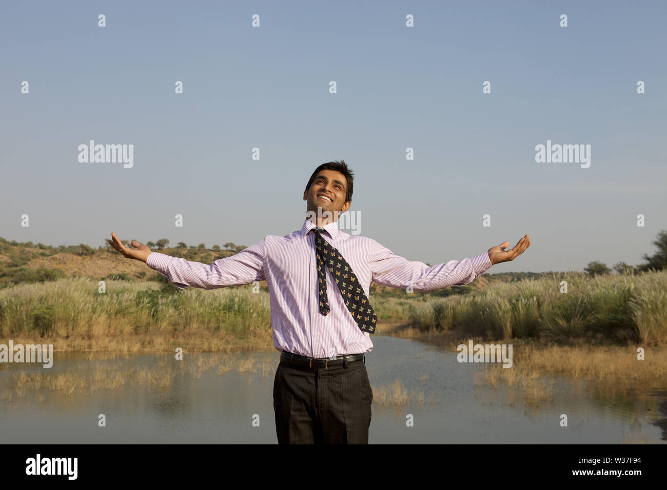 Businessman standing with his arm outstretched Stock Photo - Alamy