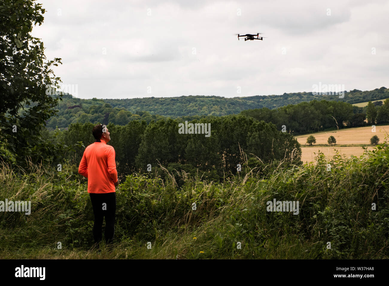 Man flying a quadcopter drone Stock Photo - Alamy
