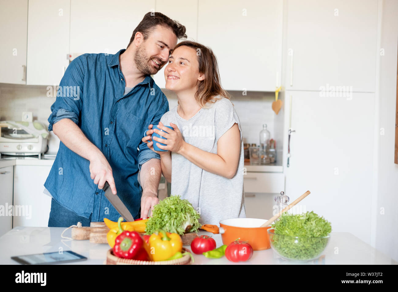 Romantic young couple in kitchen hi-res stock photography and images ...