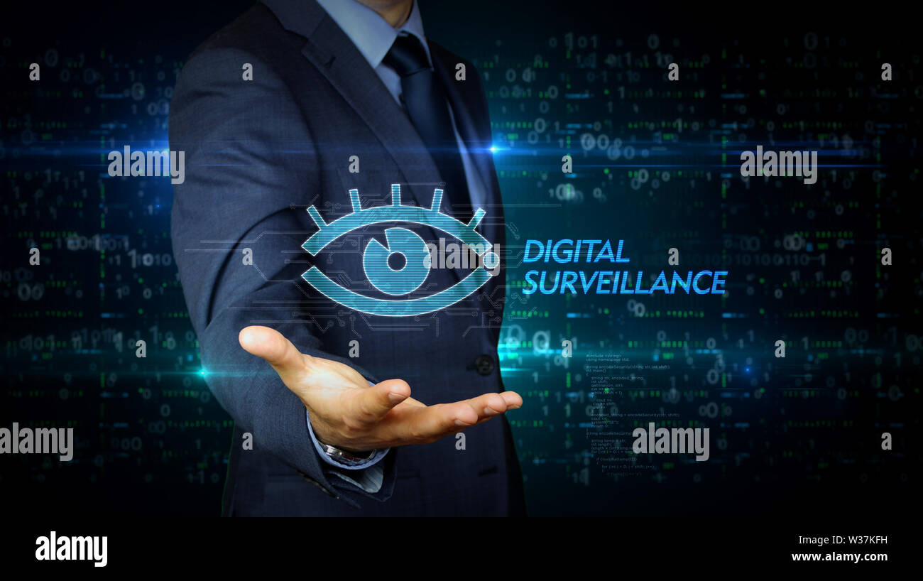 A businessman in a suit and screen with cyber eye hologram. Man using ...