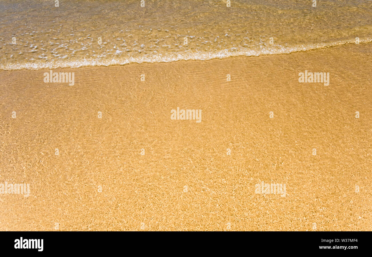 Light reflection on the surface of movement sea on sand beach Stock ...