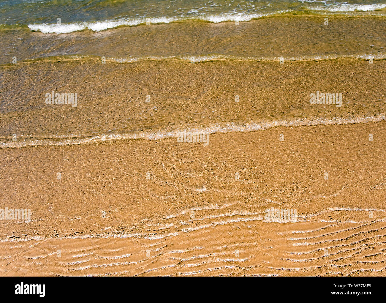 Light reflection on the surface of movement sea on sand beach Stock ...