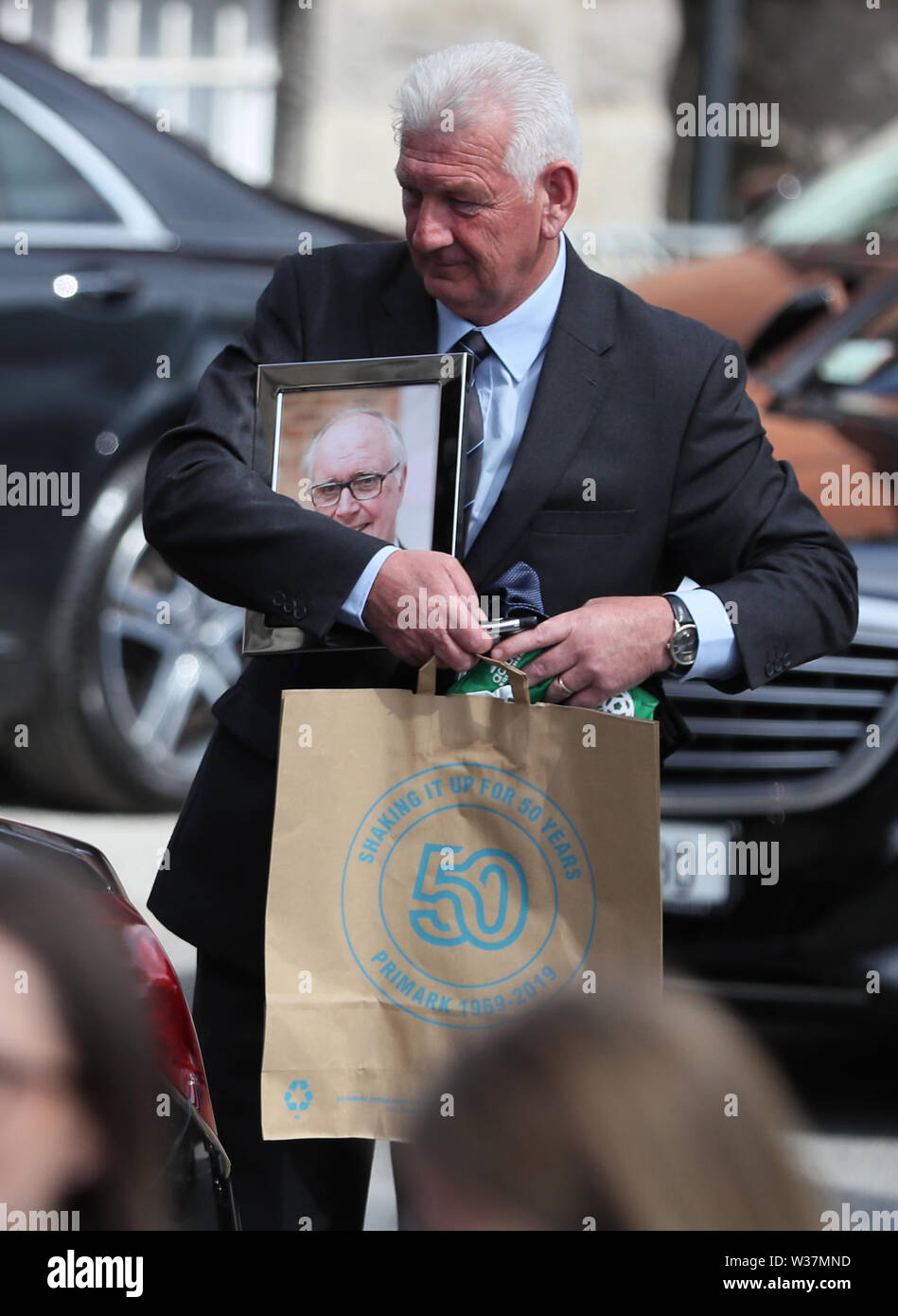 A Penneys bag and a picture of Penneys/Primark founder Arthur Ryan is ...