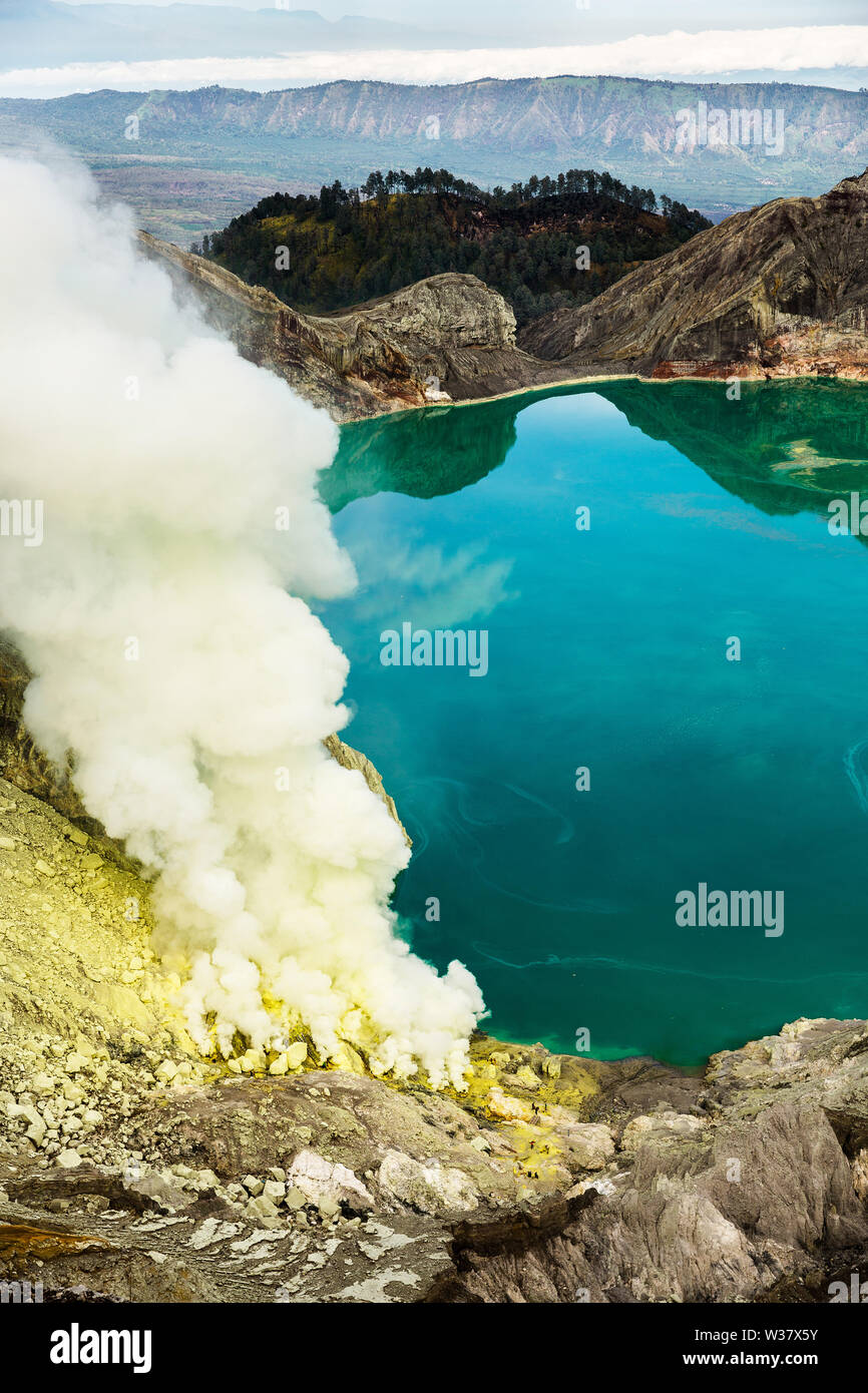 Crater of a volcano with a green sulfuric volcanic lake and volcanic ...