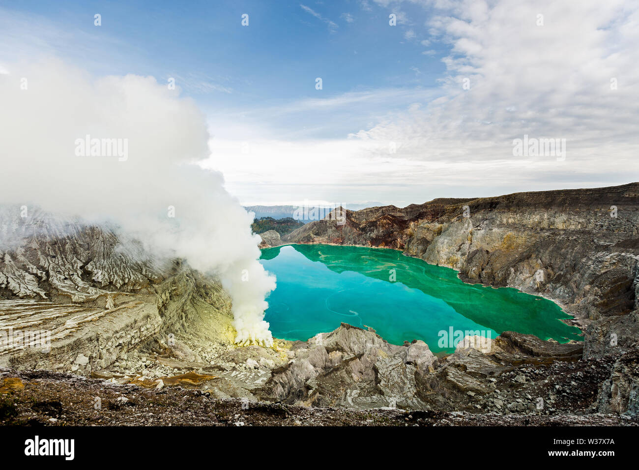 Crater of a volcano with a green sulfuric volcanic lake and volcanic ...
