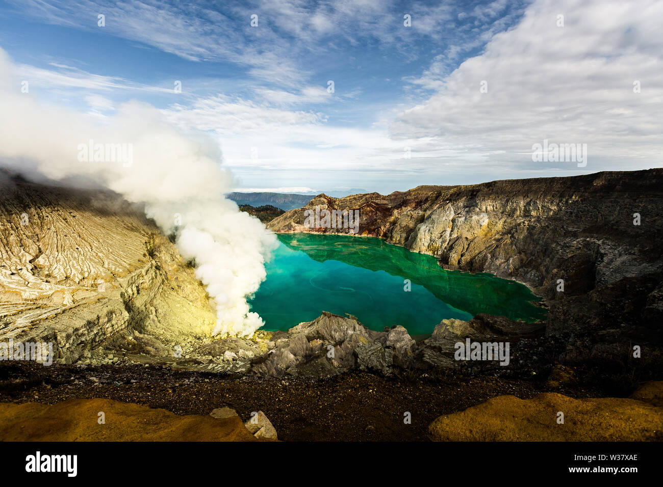 Crater of a volcano with a green sulfuric volcanic lake and volcanic ...