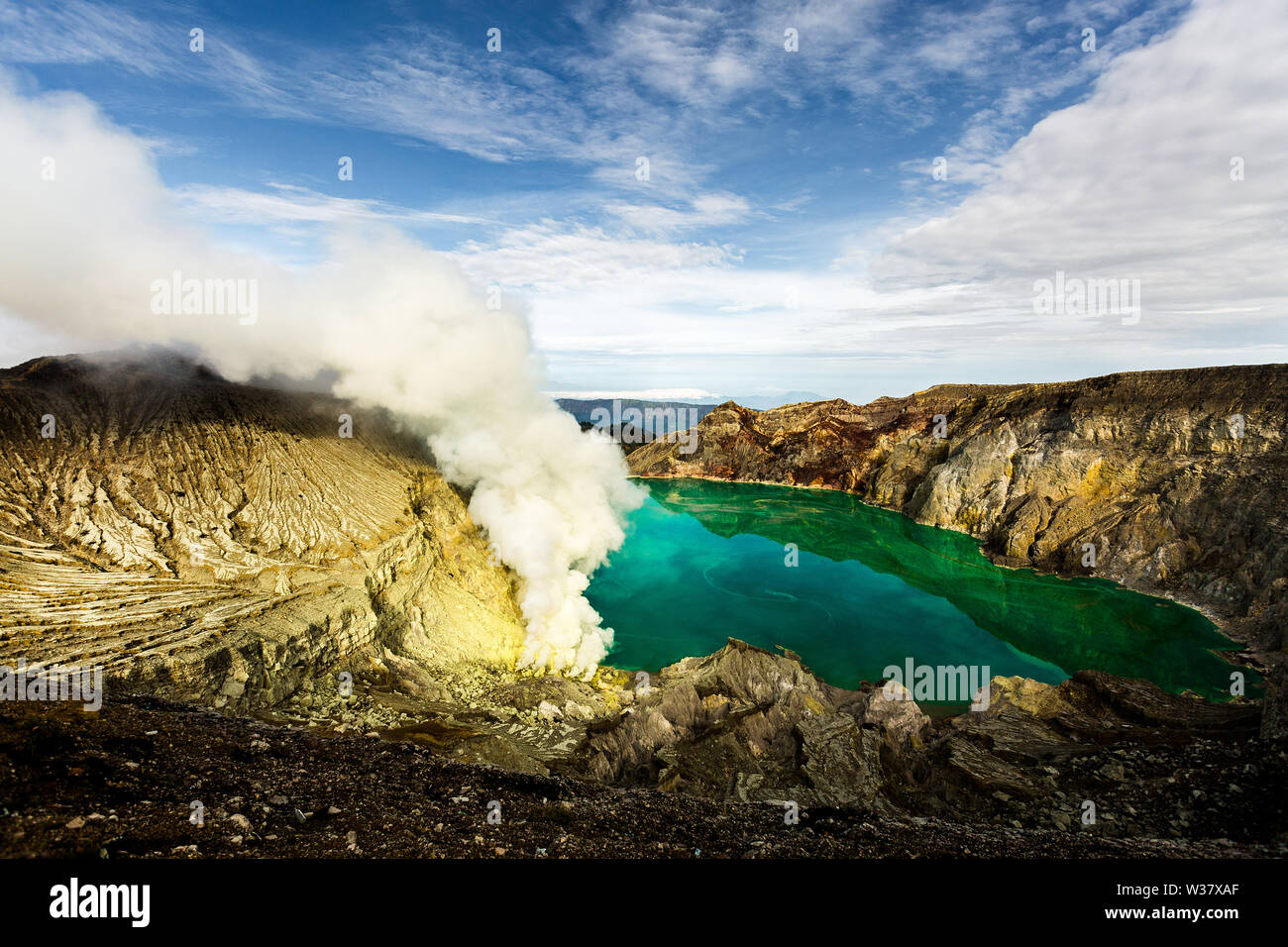 Crater of a volcano with a green sulfuric volcanic lake and volcanic ...