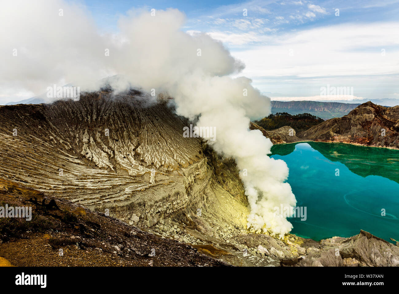 Crater of a volcano with a green sulfuric volcanic lake and volcanic ...