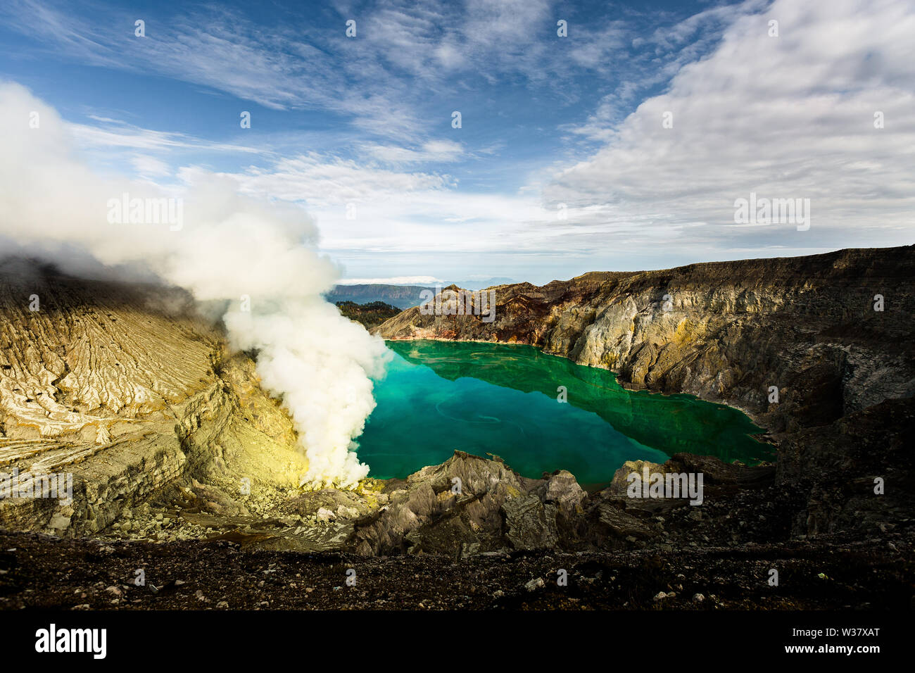 Crater of a volcano with a green sulfuric volcanic lake and volcanic ...