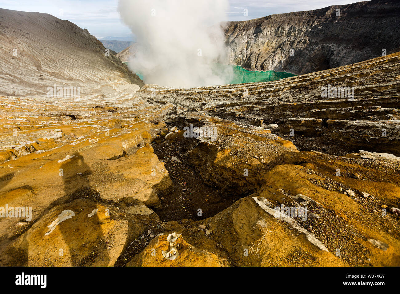 Crater of a volcano with a green sulfuric volcanic lake and volcanic ...