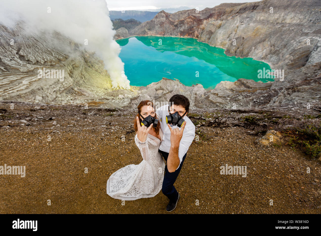 The bride and groom in respirators show sign of the horns on the ...