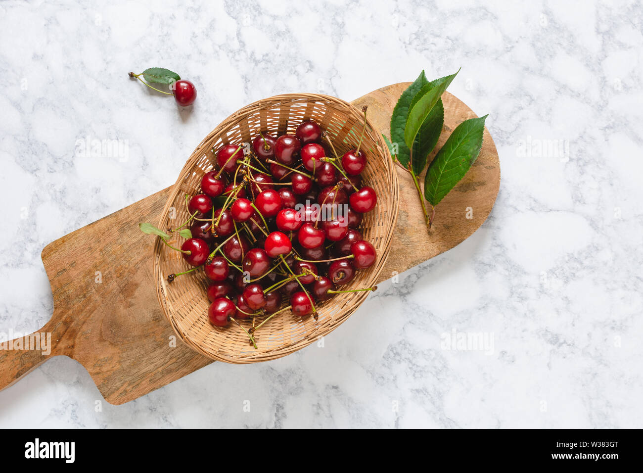 Fresh cherries in a basket on the table Stock Photo - Alamy