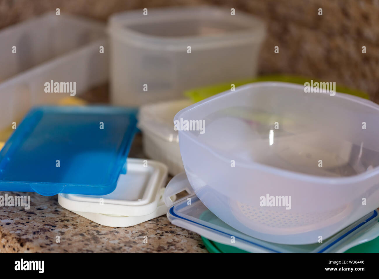 plastic storage containers and plates in the kitchen Stock Photo - Alamy