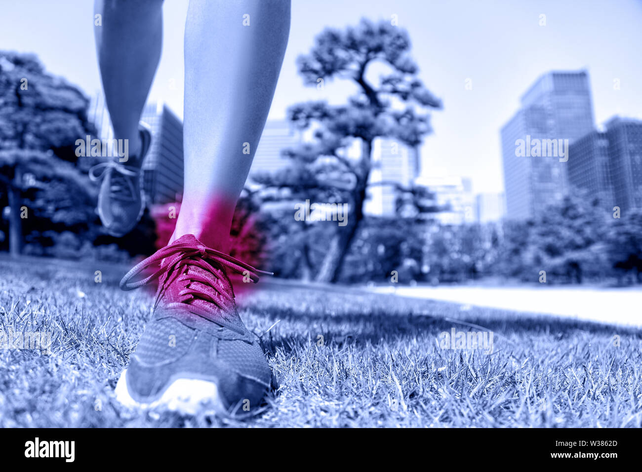 Sports injury - runner feet with ankle pain. Closeup of running shoes ...