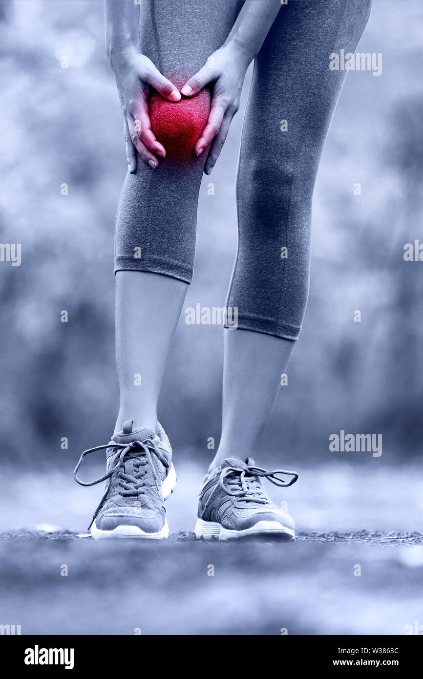 Knee injury - runner with sprained leg joint pain. Closeup of female ...