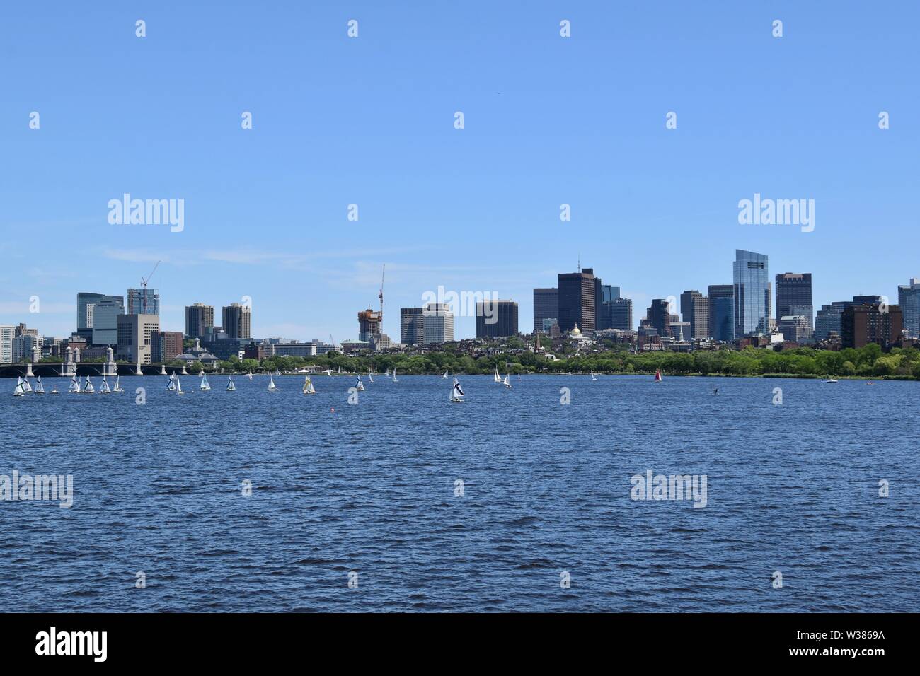 Sailboats sailing in the Charles River Basin with the Boston skyline ...