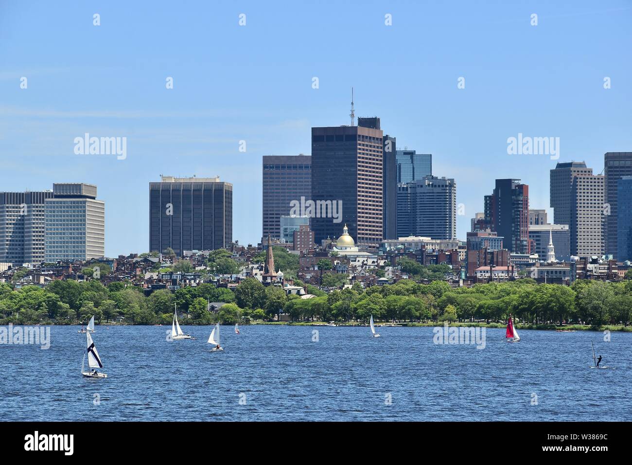 Sailboats sailing in the Charles River Basin with the Boston skyline ...