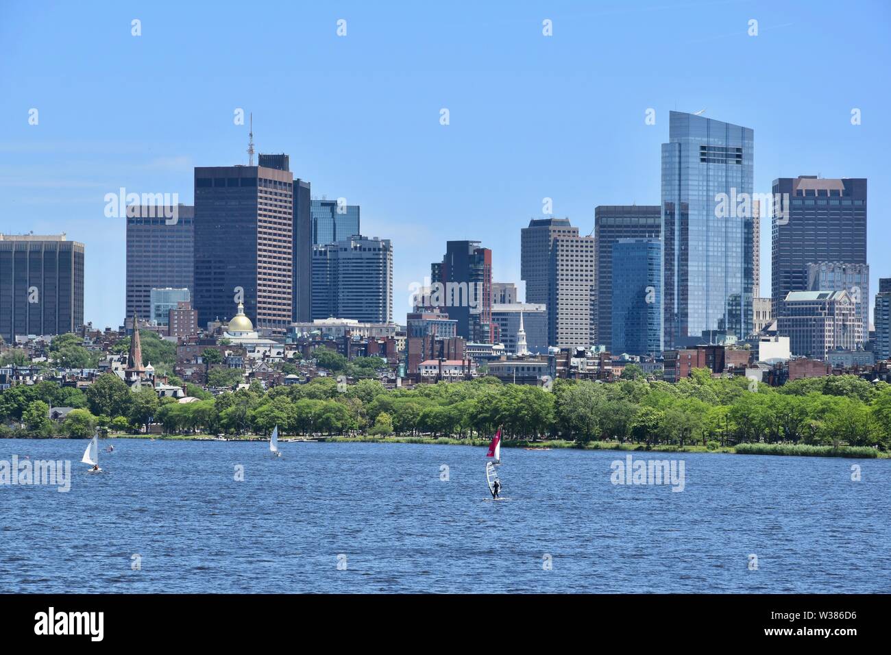 Sailboats sailing in the Charles River Basin with the Boston skyline ...