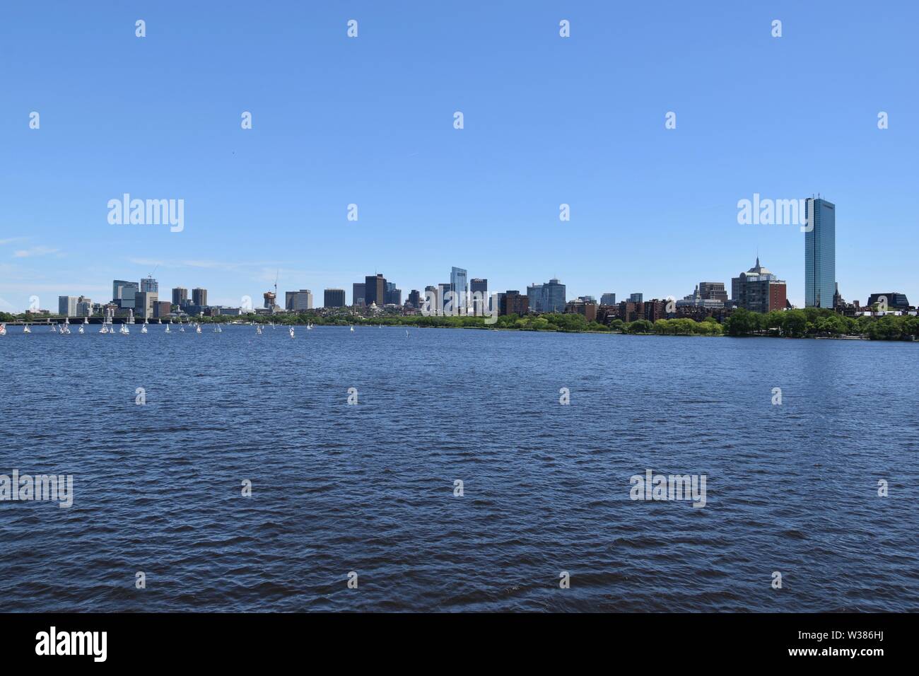Sailboats sailing in the Charles River Basin with the Boston skyline ...