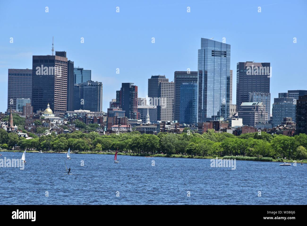 Sailboats sailing in the Charles River Basin with the Boston skyline ...