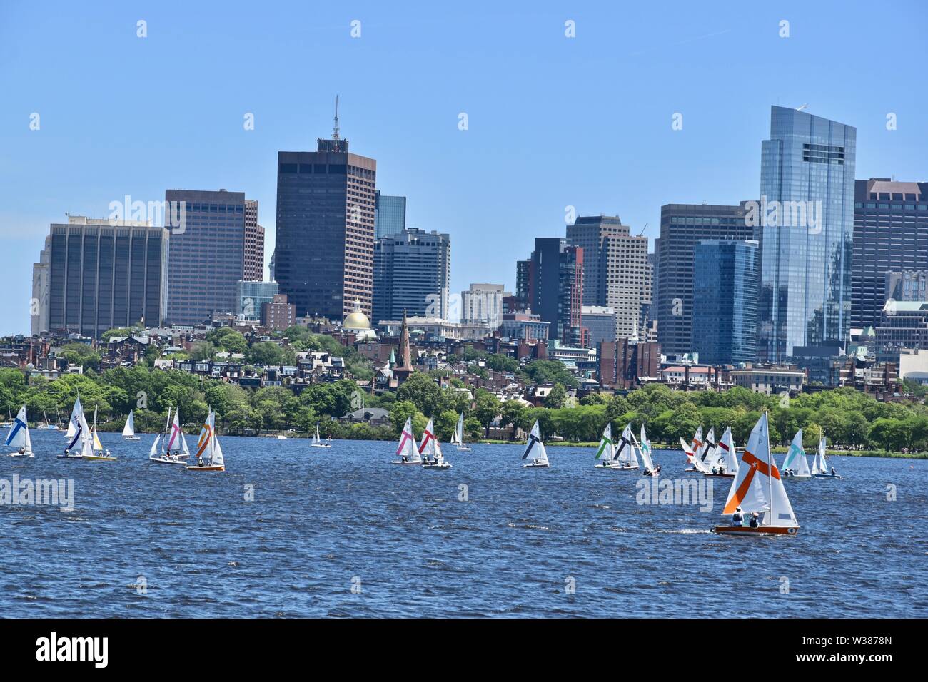 Sailboats sailing in the Charles River Basin with the Boston skyline ...