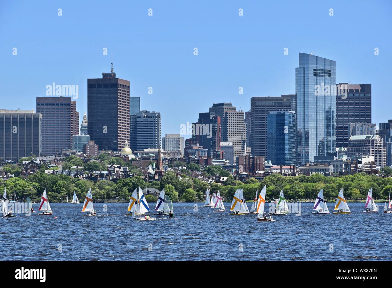 Sailboats sailing in the Charles River Basin with the Boston skyline ...