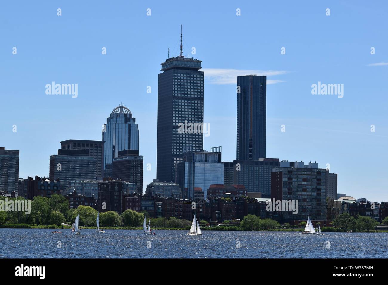 Sailboats sailing in the Charles River Basin with the Boston skyline ...