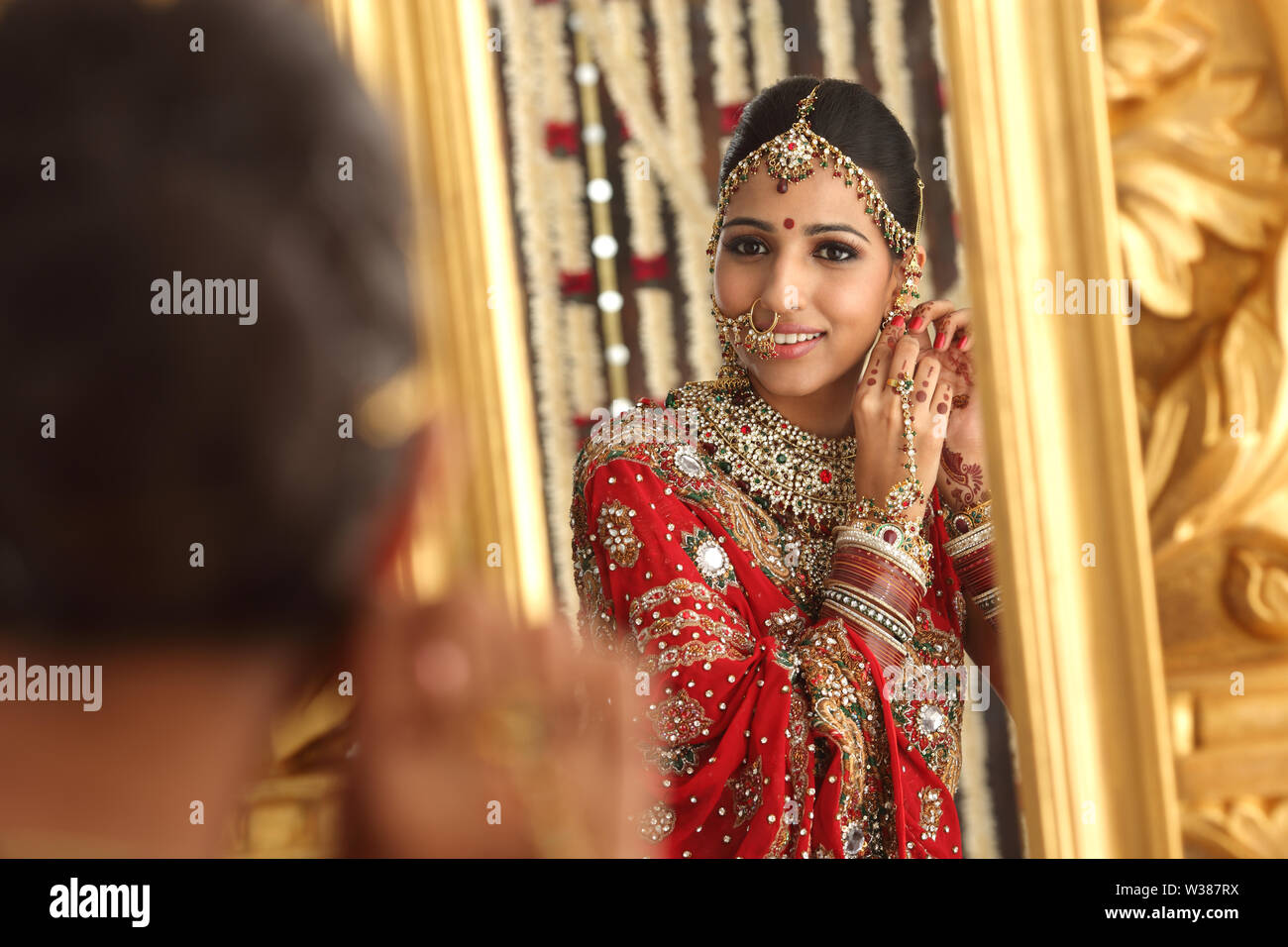 Indian bride getting dressed hi-res stock photography and images - Alamy