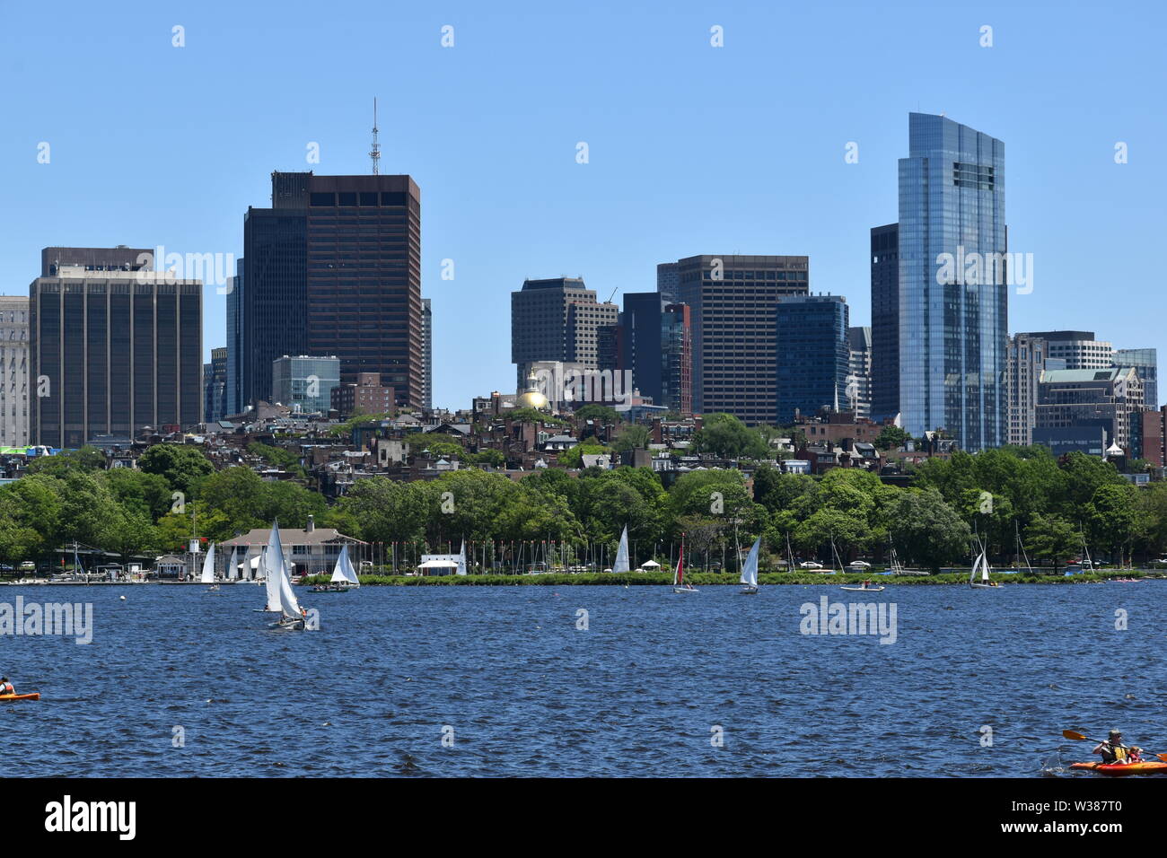 Sailboats sailing in the Charles River Basin with the Boston skyline ...