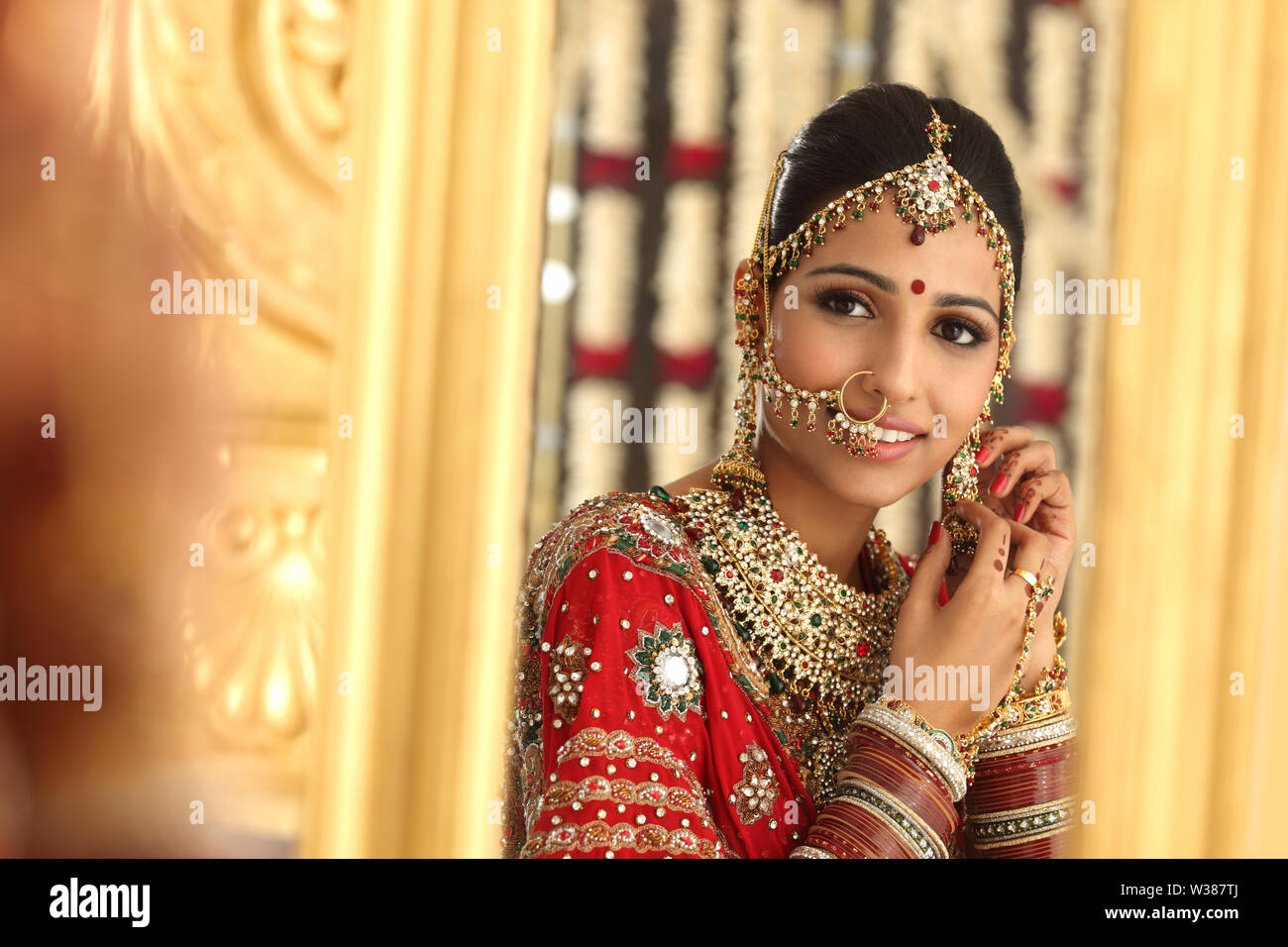 Indian bride getting dressed hi-res stock photography and images - Alamy