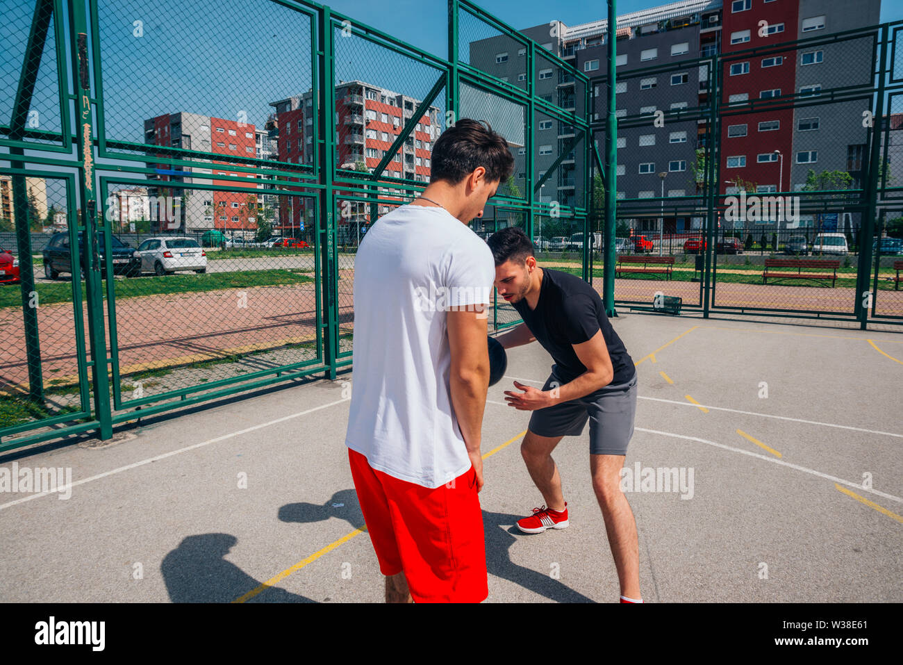 Two street basketball players playing one on one lot of close up action ...