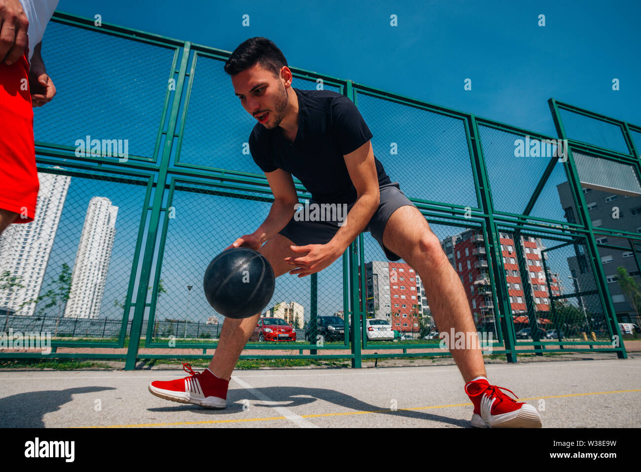Two street basketball players playing one on one lot of close up action ...