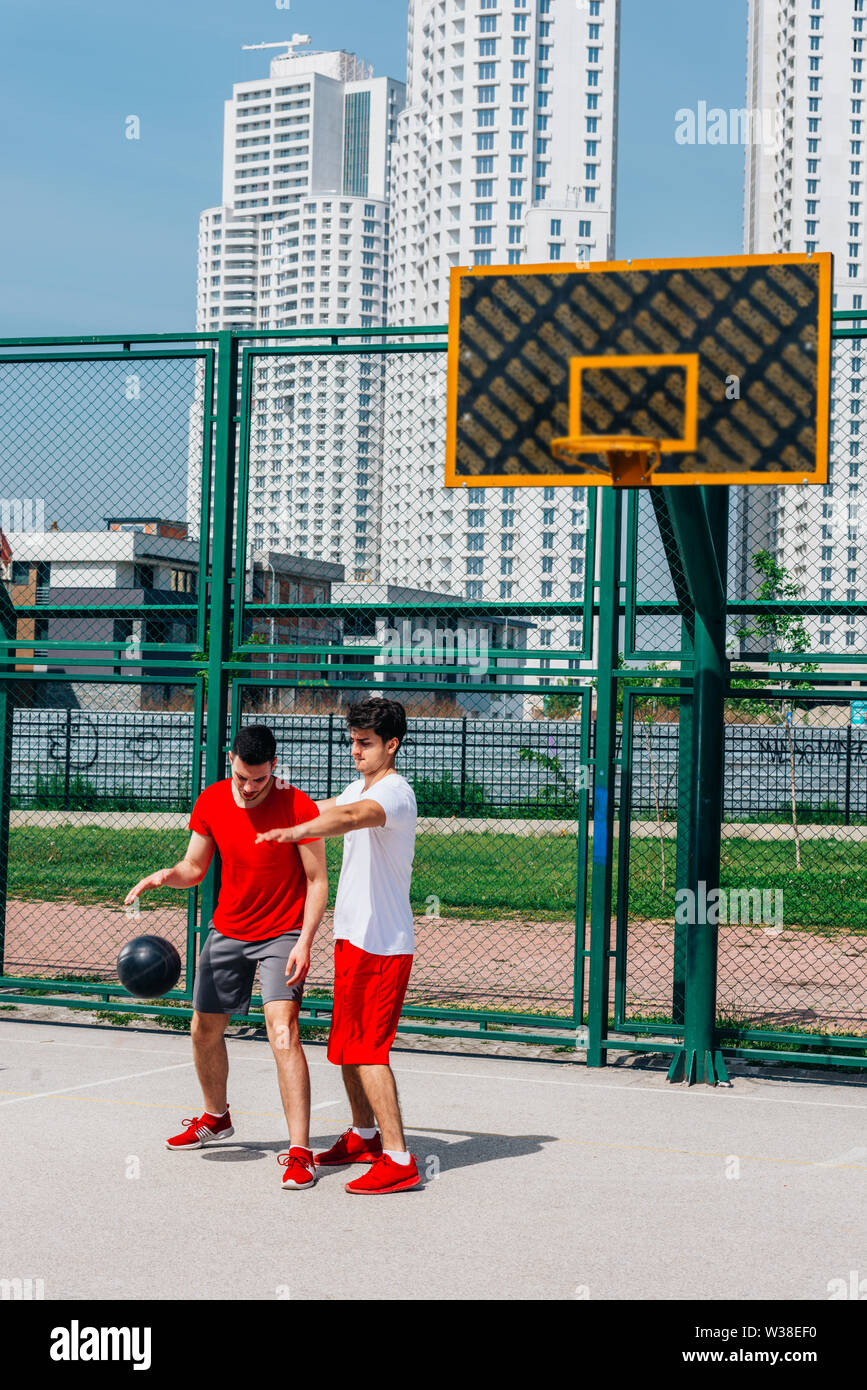 Basketball players playing ball(pushing, dribbling) on an urban ...