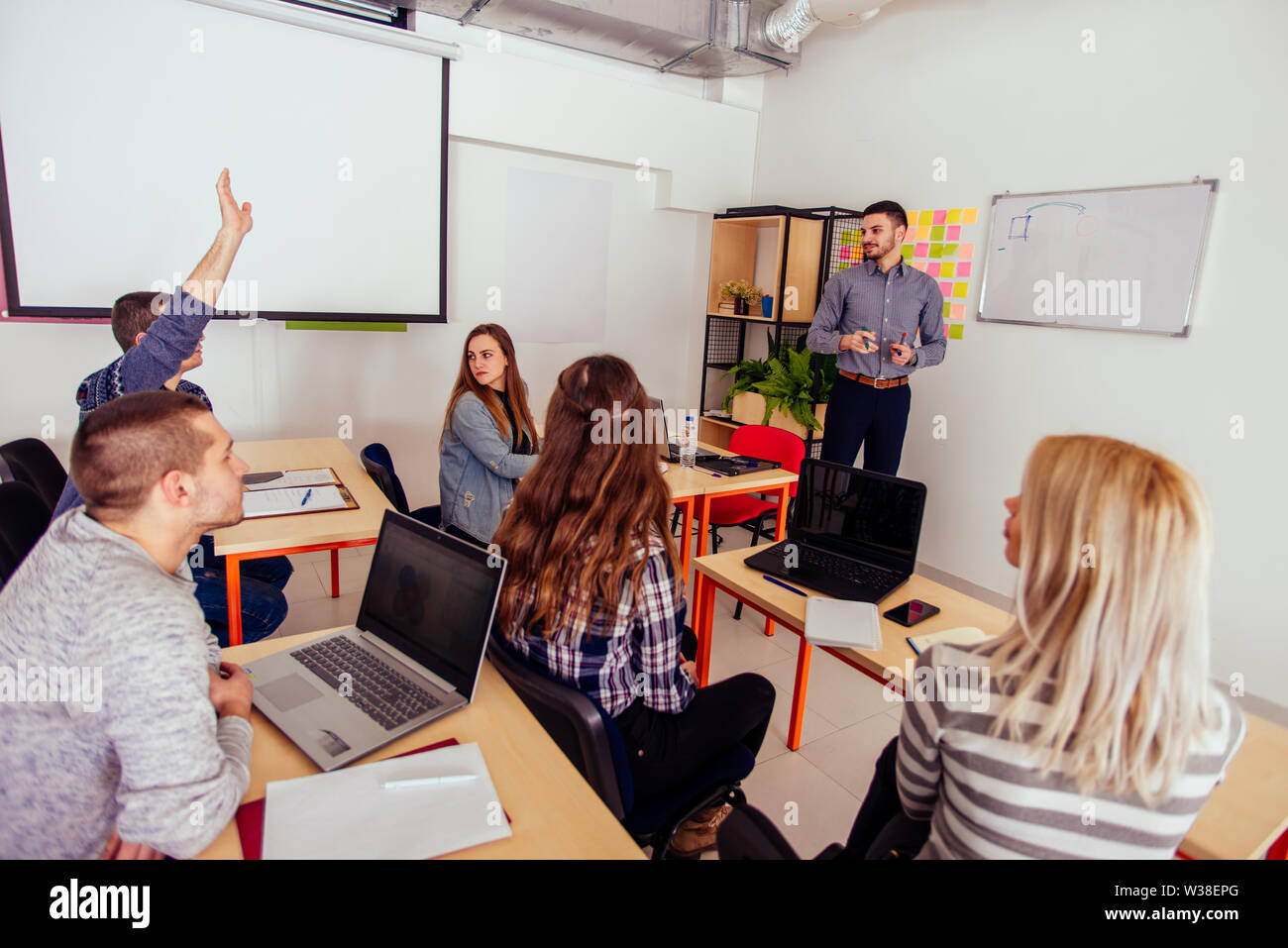 Urban students are listening to a lecture and discussing on class Stock ...