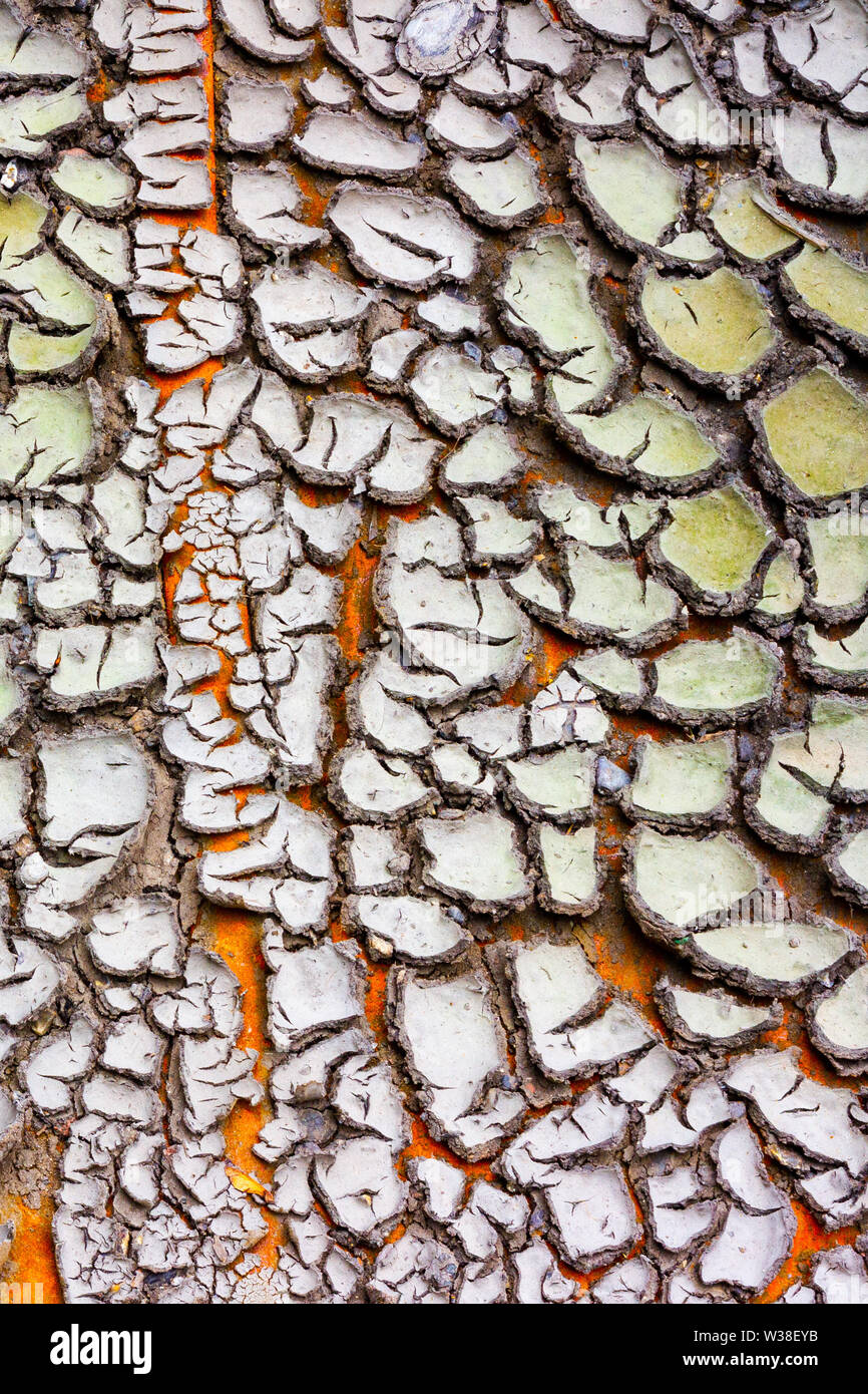 Dried mud on an orange metal background Stock Photo - Alamy