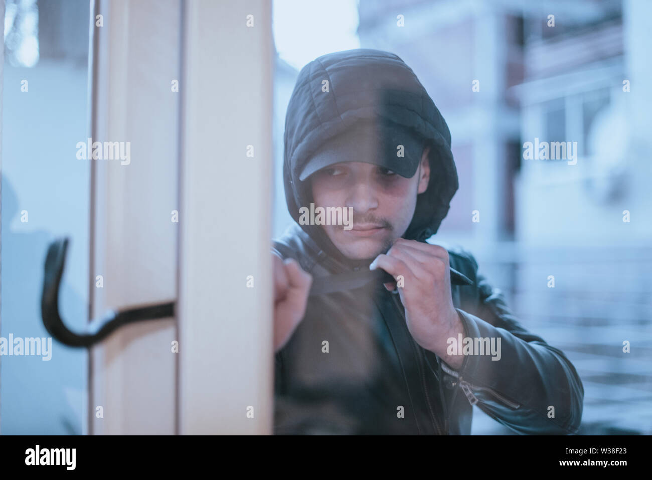 Burglar entering through window hi-res stock photography and images - Alamy