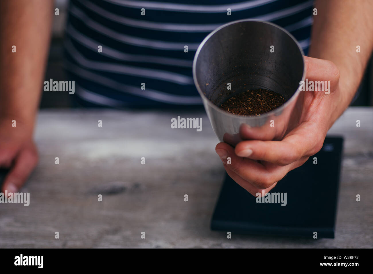 Young barista standing and show fresh coffee at coffee bar Stock Photo ...