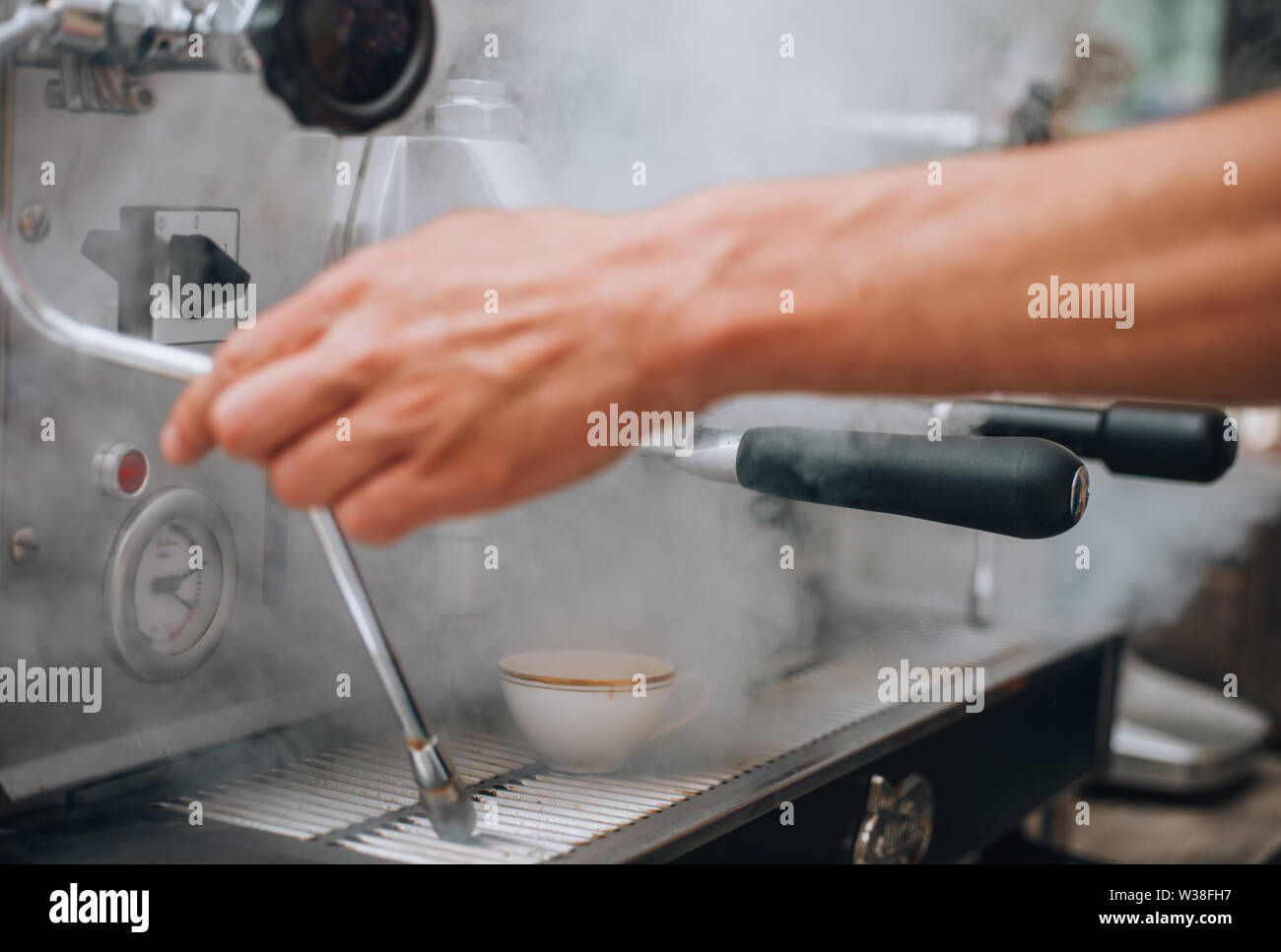 Espresso machine pouring strong looking fresh coffee in a white cup ...