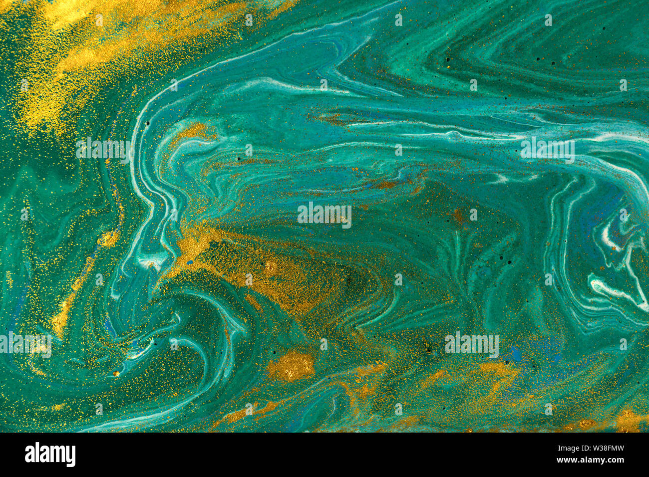 Liquid uneven green marbling pattern with golden glitter and glare of ...